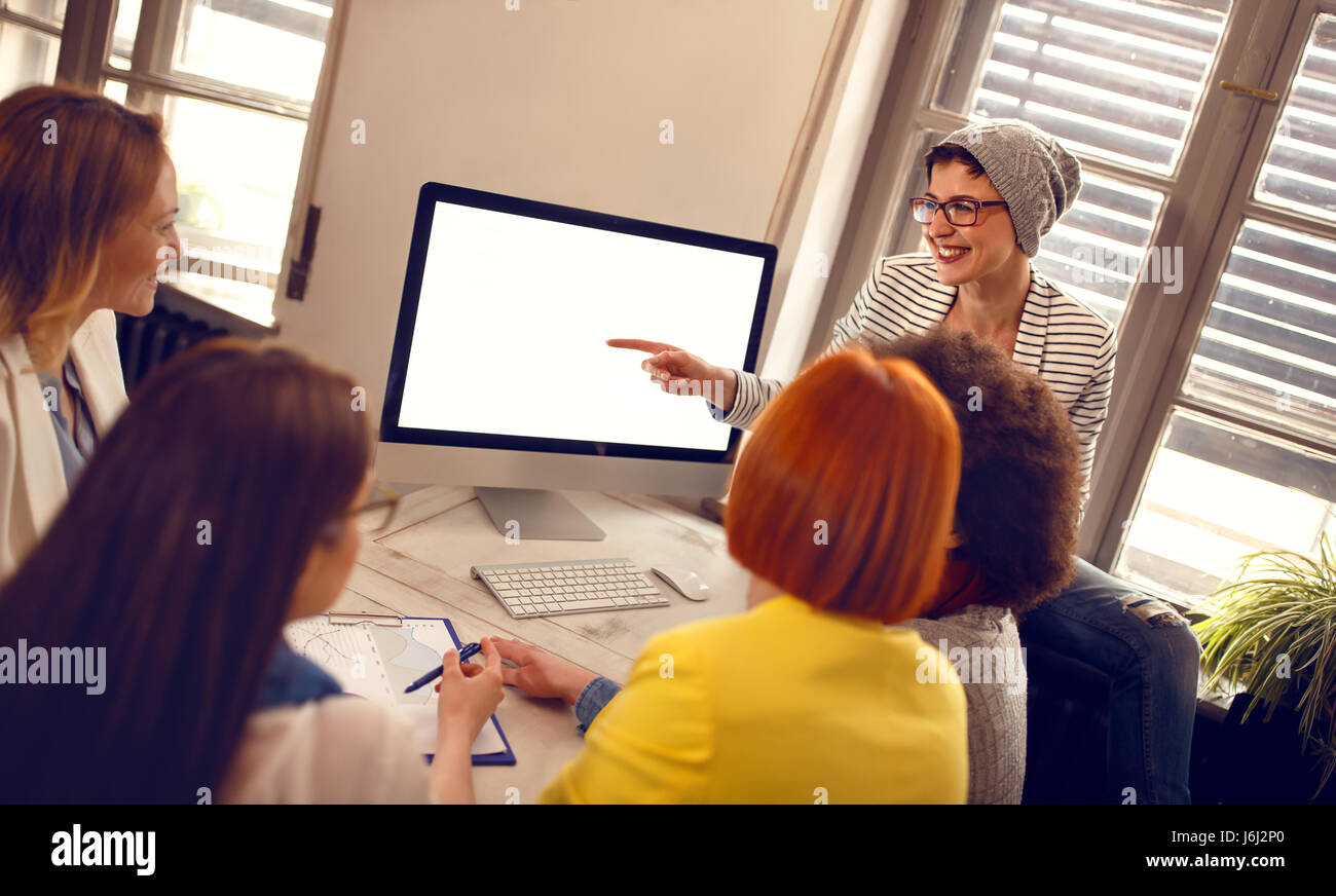 Young female group planning project in office Stock Photo - Alamy