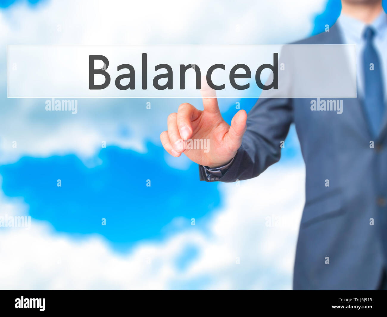 Balanced - Businessman hand pressing button on touch screen interface ...