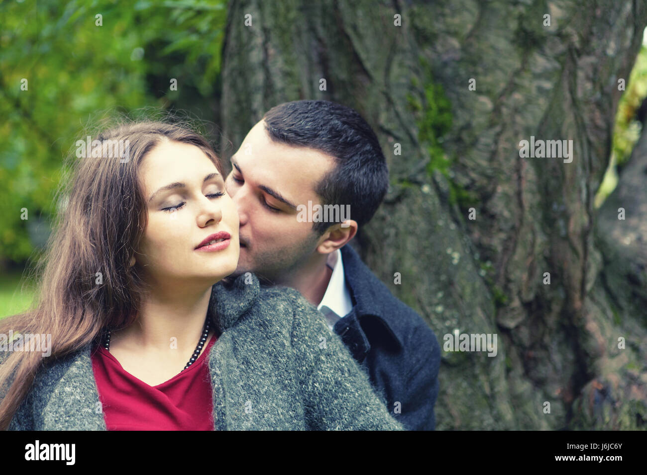 sad young couple in autumn park together faces close Stock Photo - Alamy