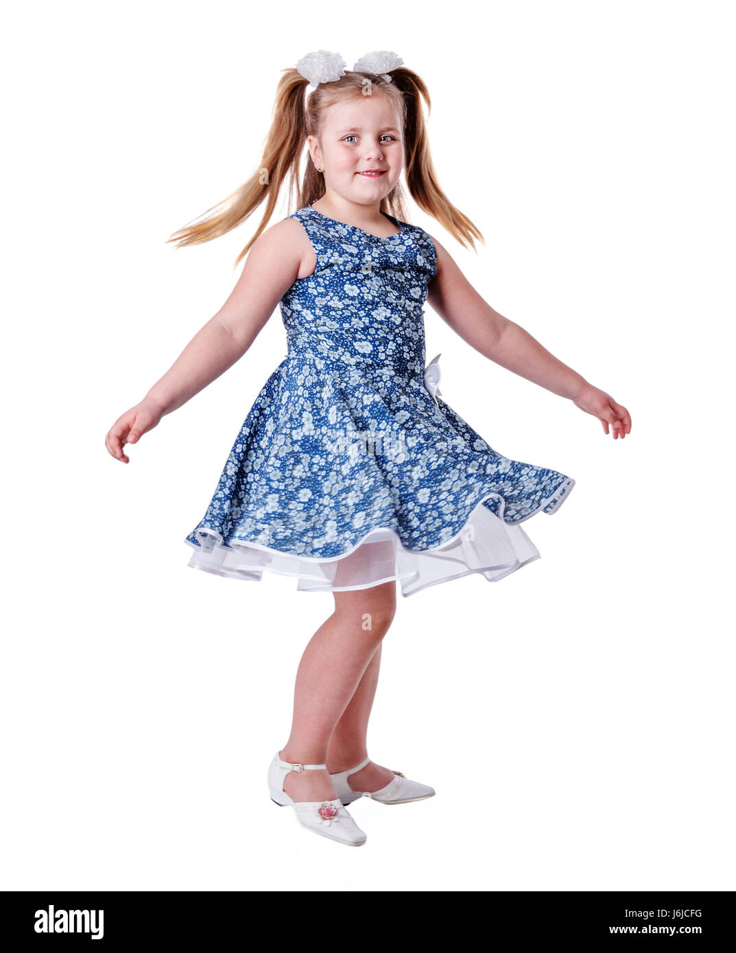 Cheerful girl spinning on floor isolated on white Stock Photo - Alamy