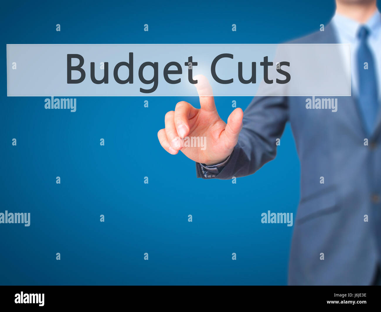 Budget Cuts - Businessman hand touch button on virtual screen interface ...
