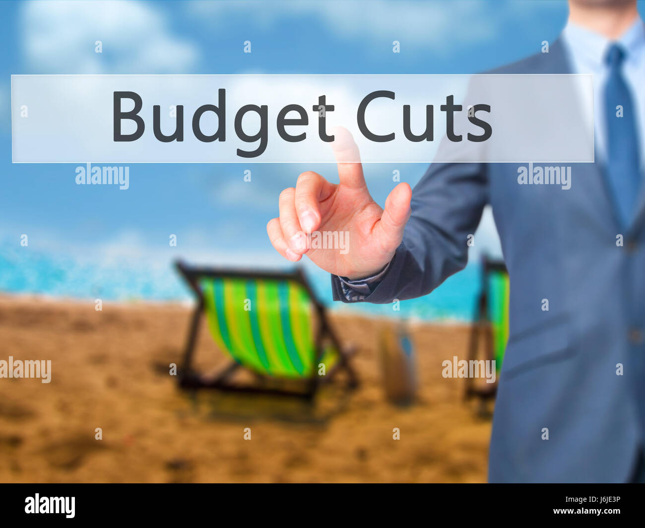 Budget Cuts - Businessman hand touch button on virtual screen interface ...