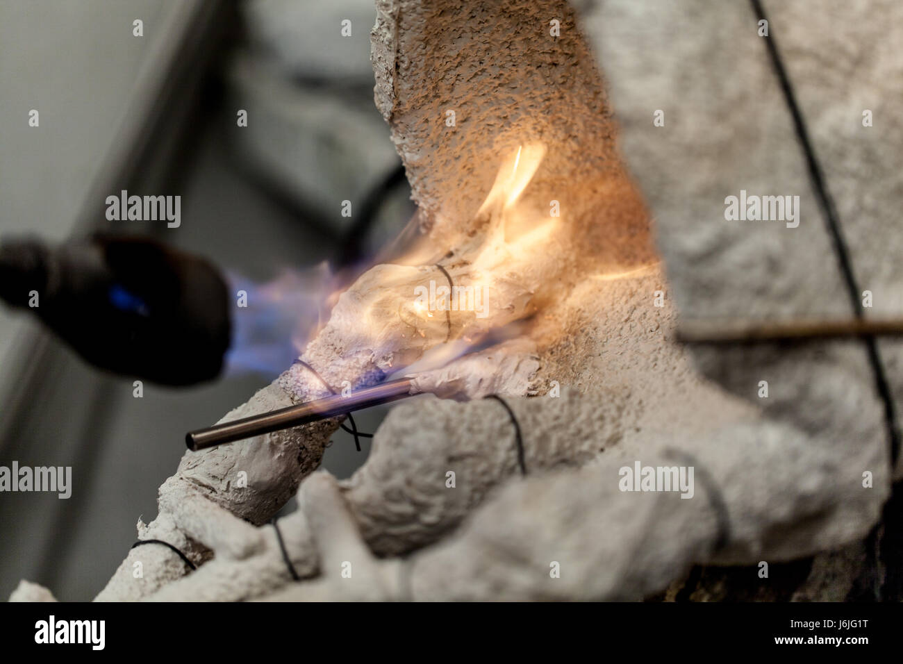 male artisan working with a welding torch on fire Stock Photo - Alamy