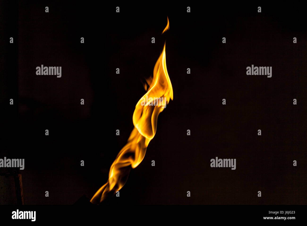 small burning flame on a black background Stock Photo - Alamy