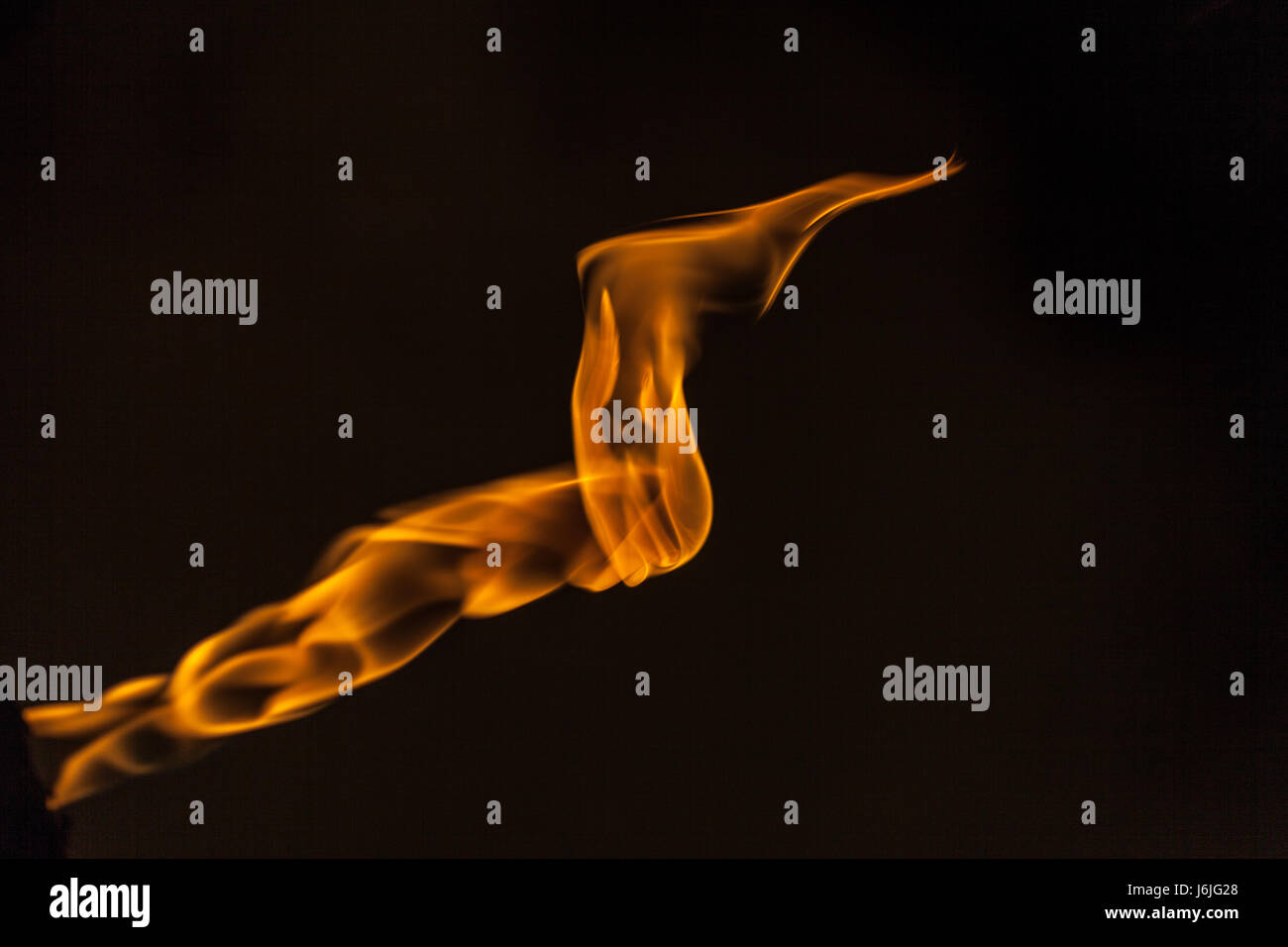 small burning flame on a black background Stock Photo - Alamy