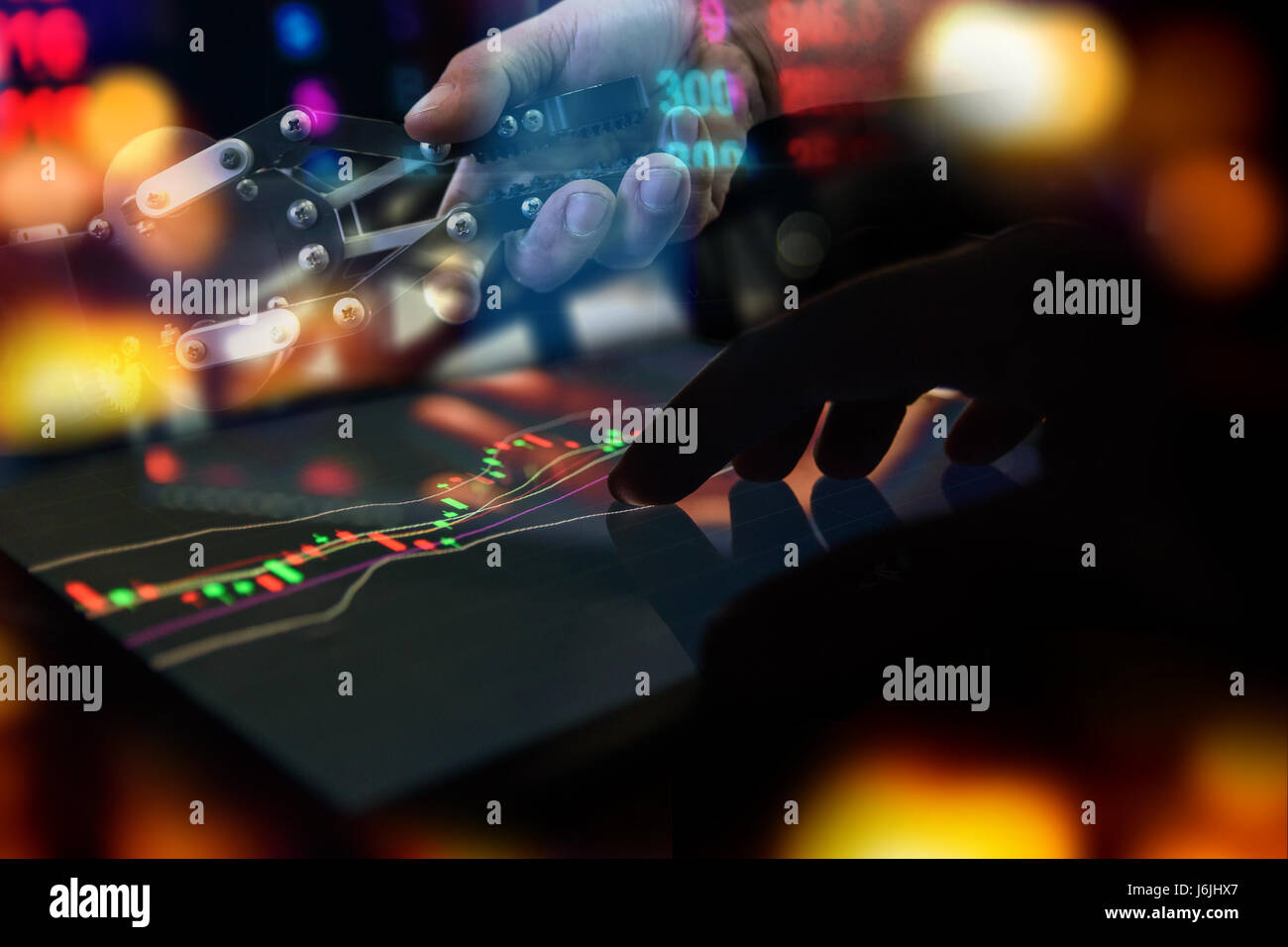 Silhouette finger on tablet with graph technical trading screen with ...
