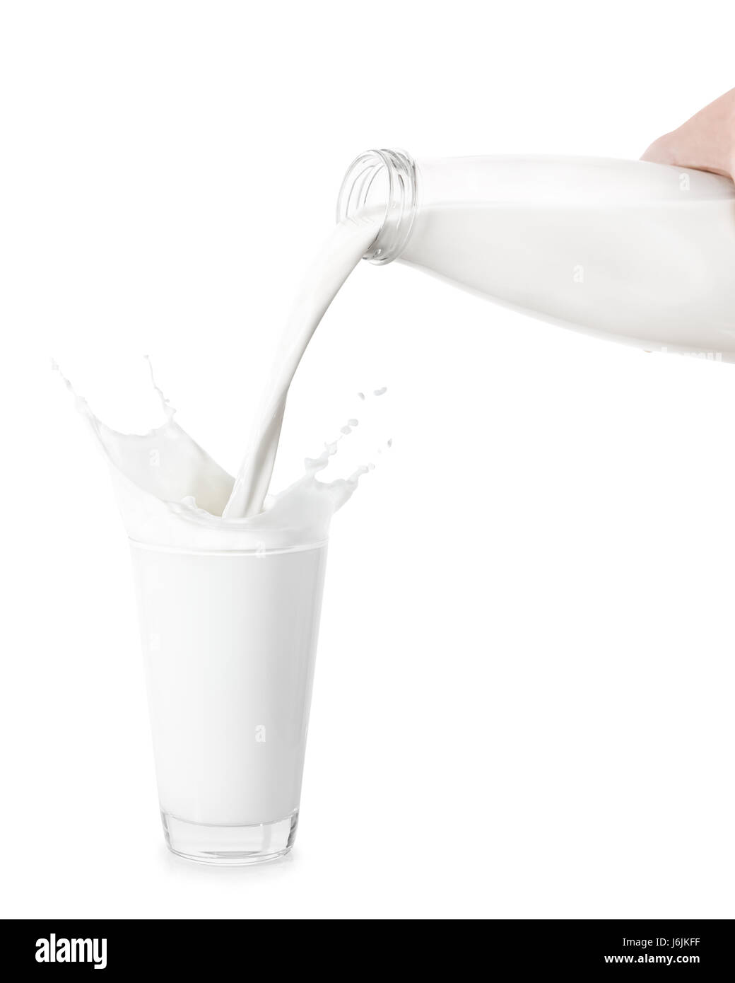 milk from bottle pouring into glass isolated on white background ...