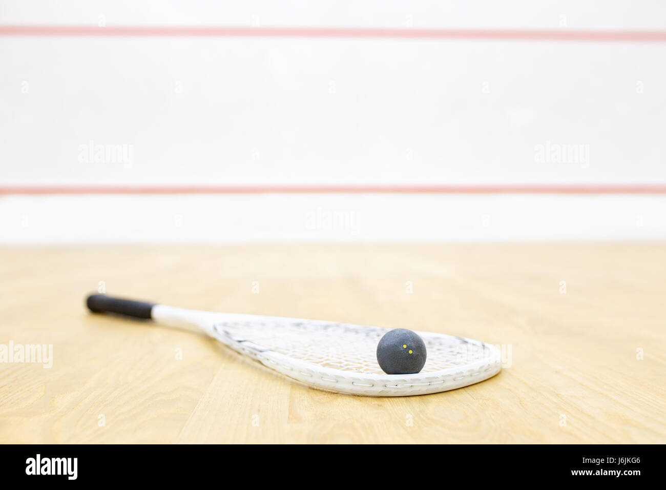 racket and ball for squash game. Racquetball equipment on the court and ...