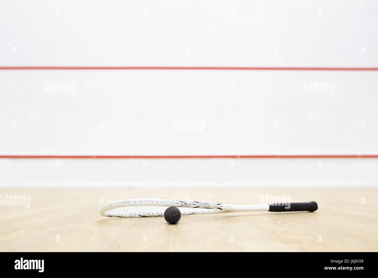 squash racket and ball on the wooden floor. Racquetball equipment on ...