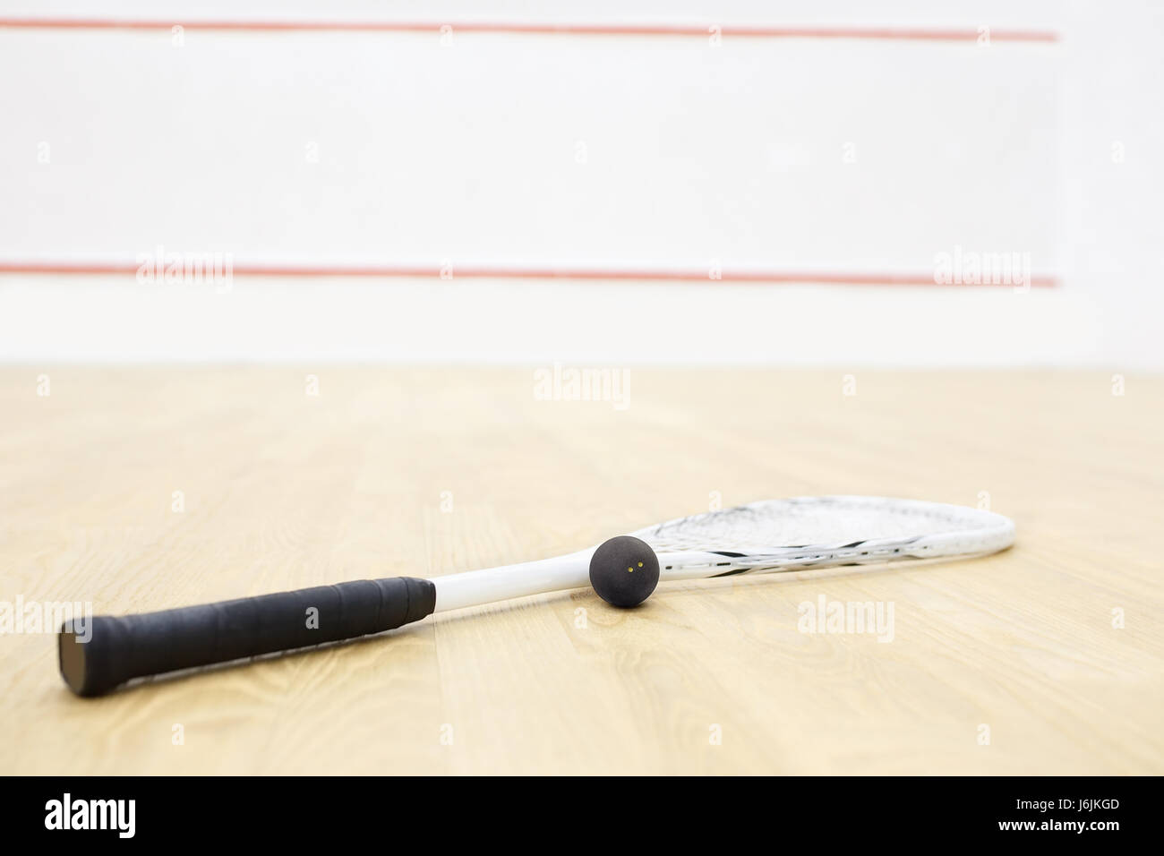 squash racket and ball. Racquetball equipment on the court and wall ...