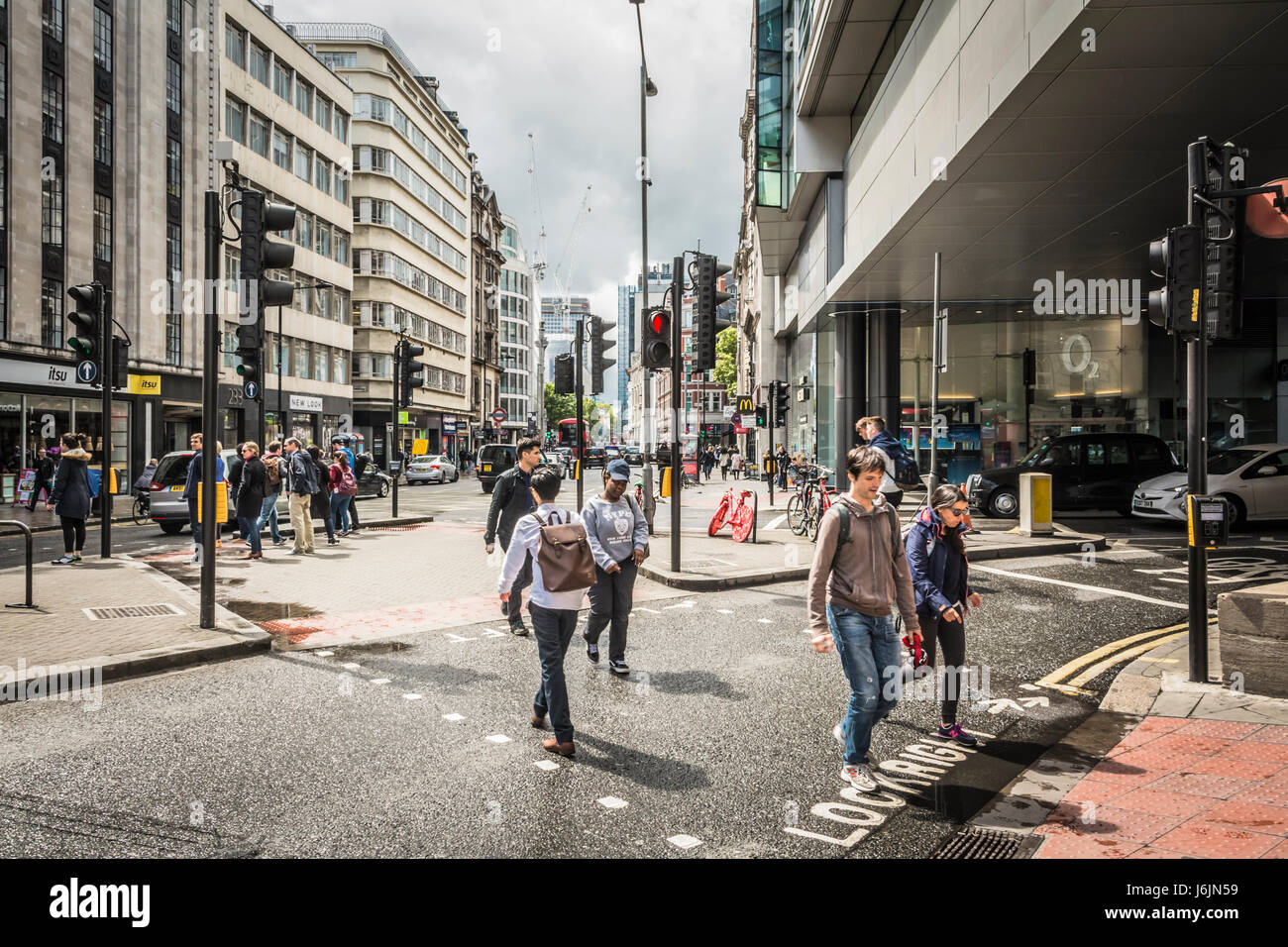 Pedestrians crossing a road in central hi-res stock photography and ...