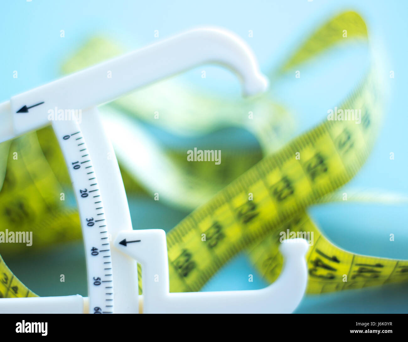 Fat caliper and measuring tape used to measure waistline, bodyfat ...