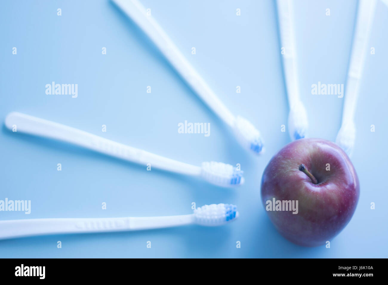 Dental toothbrushes to clean teeth and fresh red apple for healthy ...