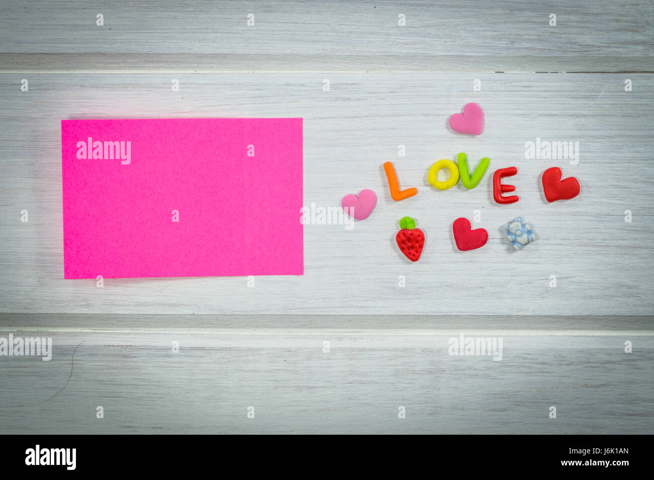 LOVE text, paper note on plank wood background Stock Photo - Alamy