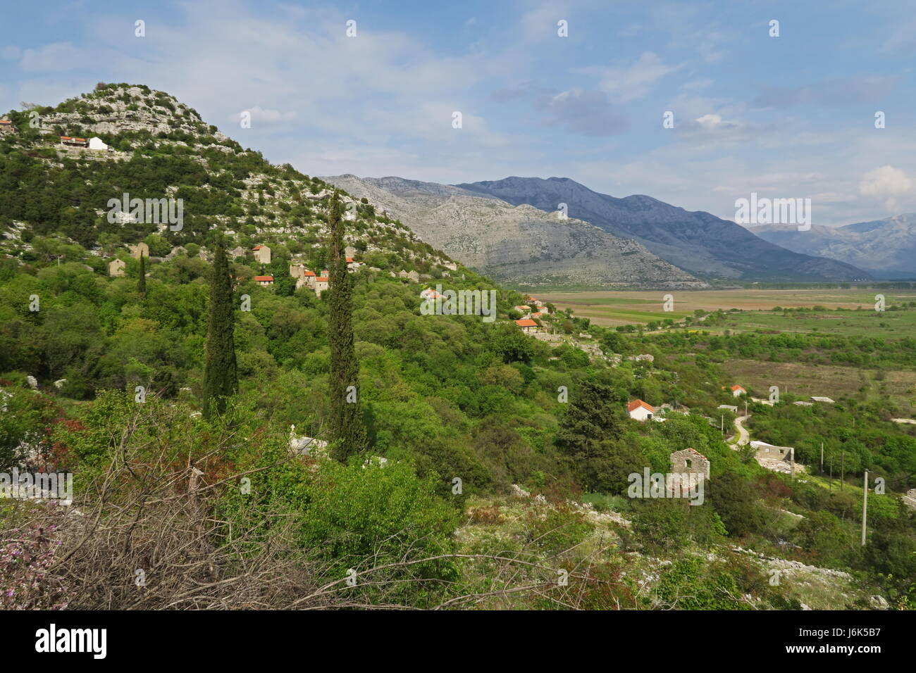 view of hillside village above karst field Popovo Polje karst field ...