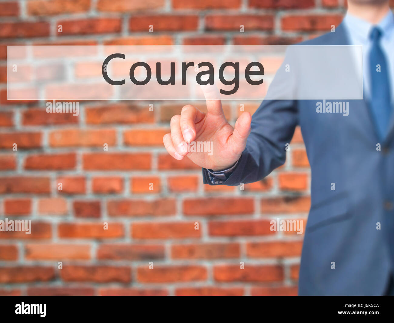 Courage - Businessman hand touch button on virtual screen interface ...