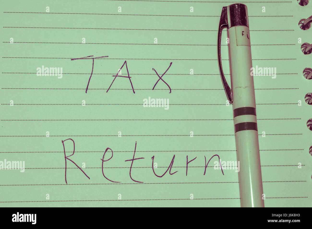 tax return hand written on note paper with pen, financial concept Stock ...