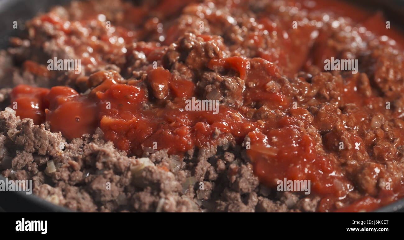 roasting minced beef with tomato paste in a pan, wide photo Stock Photo ...