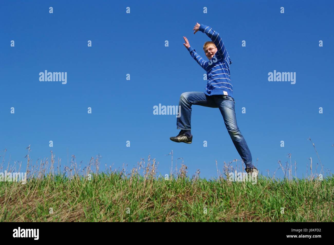 teenager jumping for joy and runs Stock Photo - Alamy