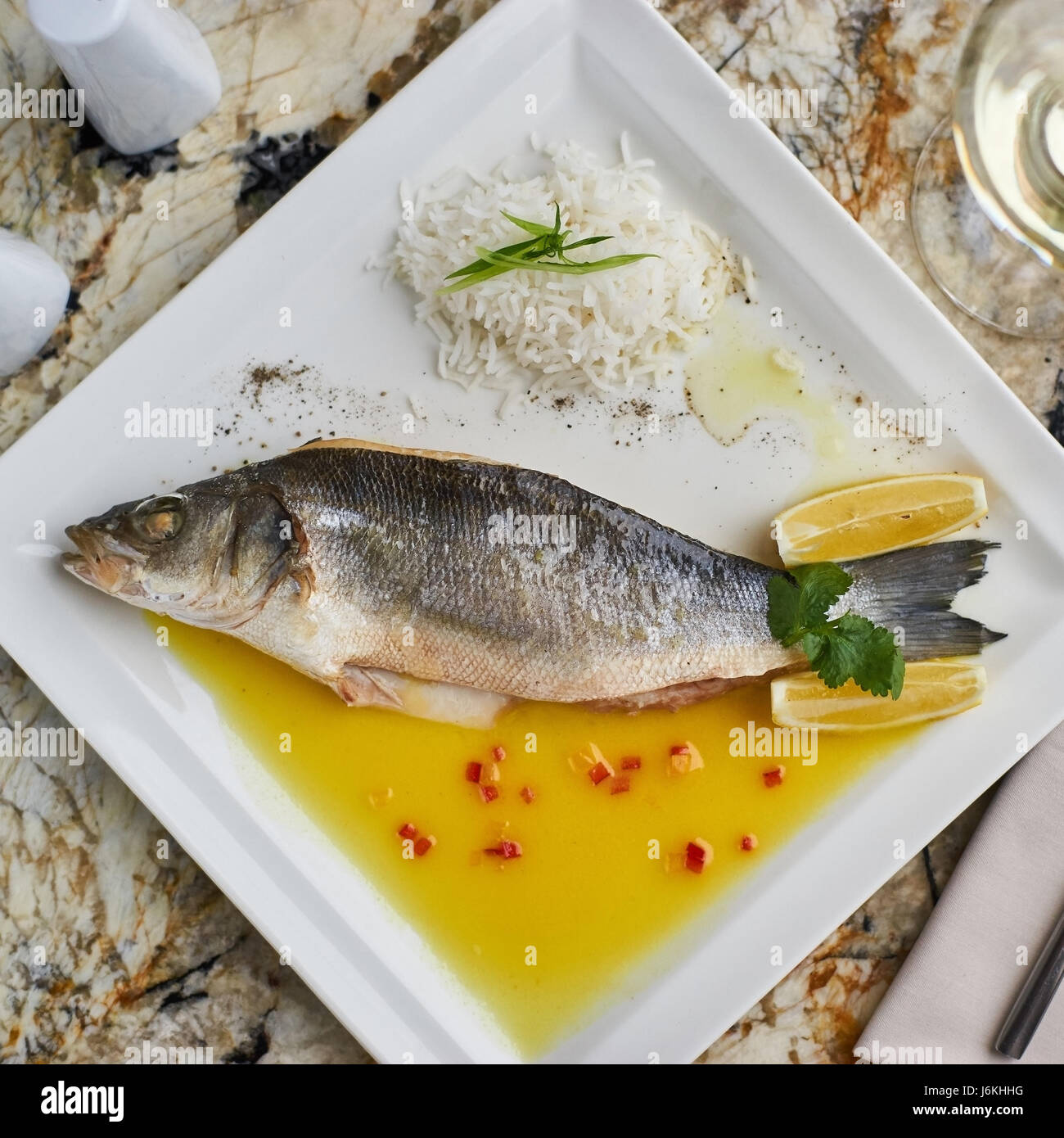 Whole boiled wolffish on plate Stock Photo - Alamy