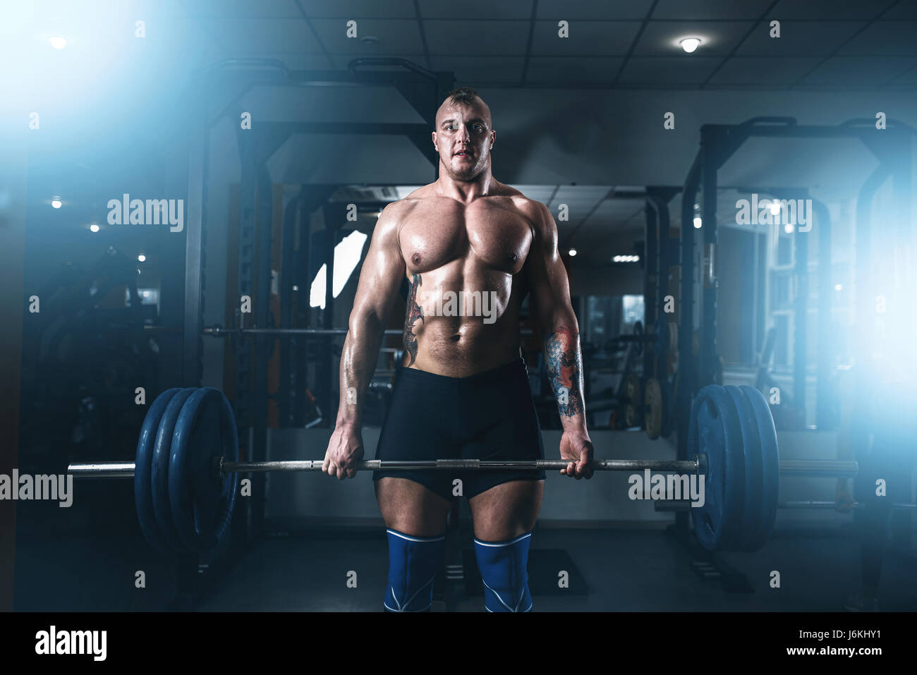 Strong athlete exercise with weight in fit gym. Fitness training with ...