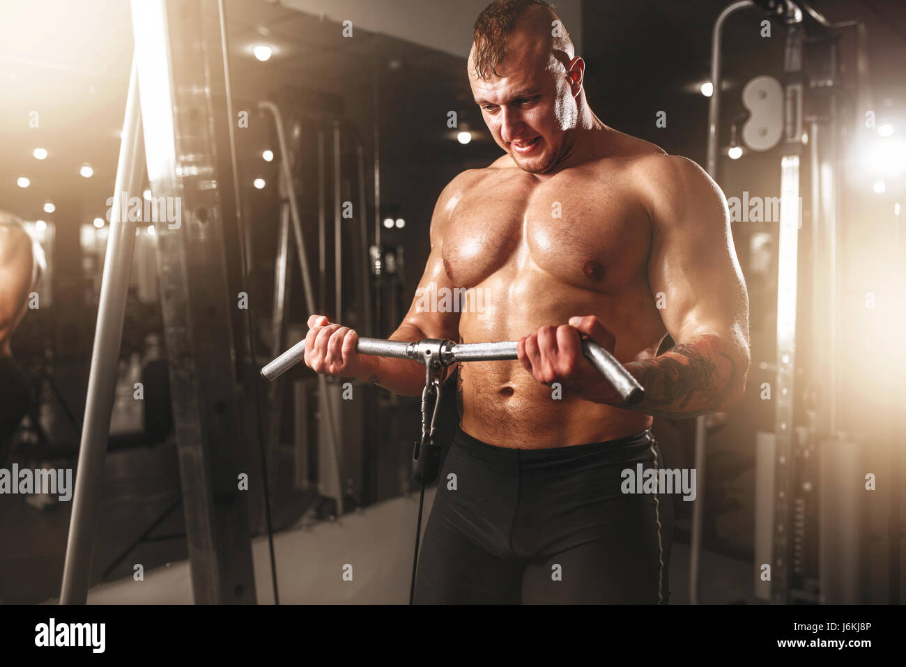 Strong athlete with muscular body lifting barbell, bodybuilding workout ...