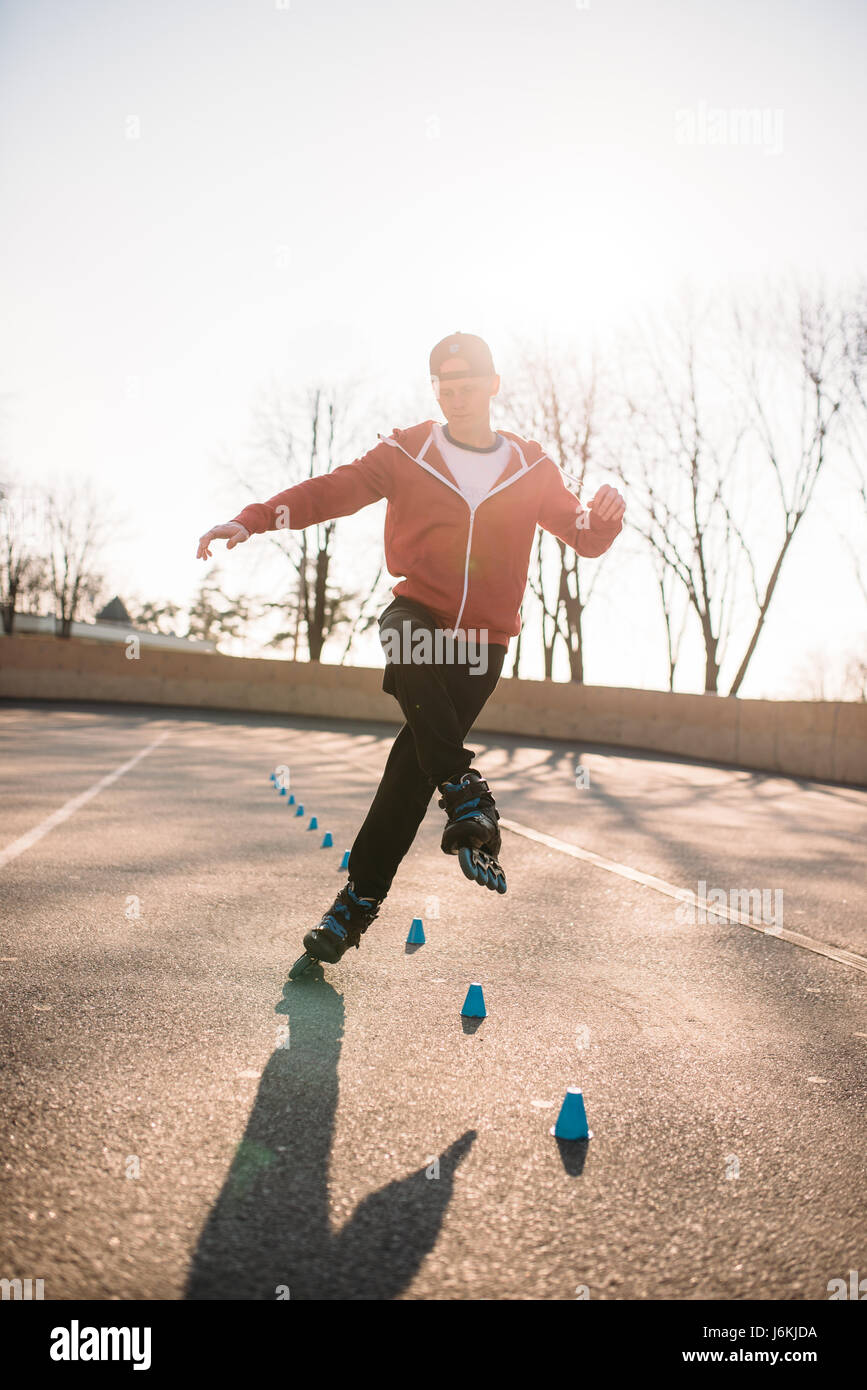 Rollerskater, rollerskating trick exercise in park. Male roller skater ...