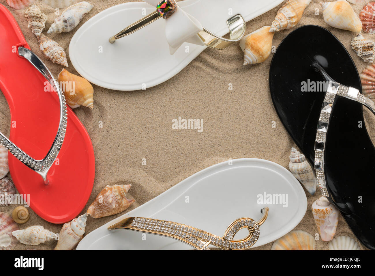 Frame, four pairs slippers in the sand beach. View from above Stock ...
