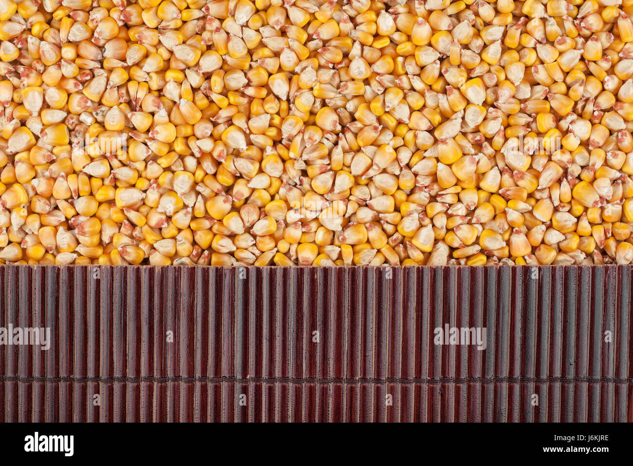 Beautiful bamboo mat on corn grains as agricultural background. View ...