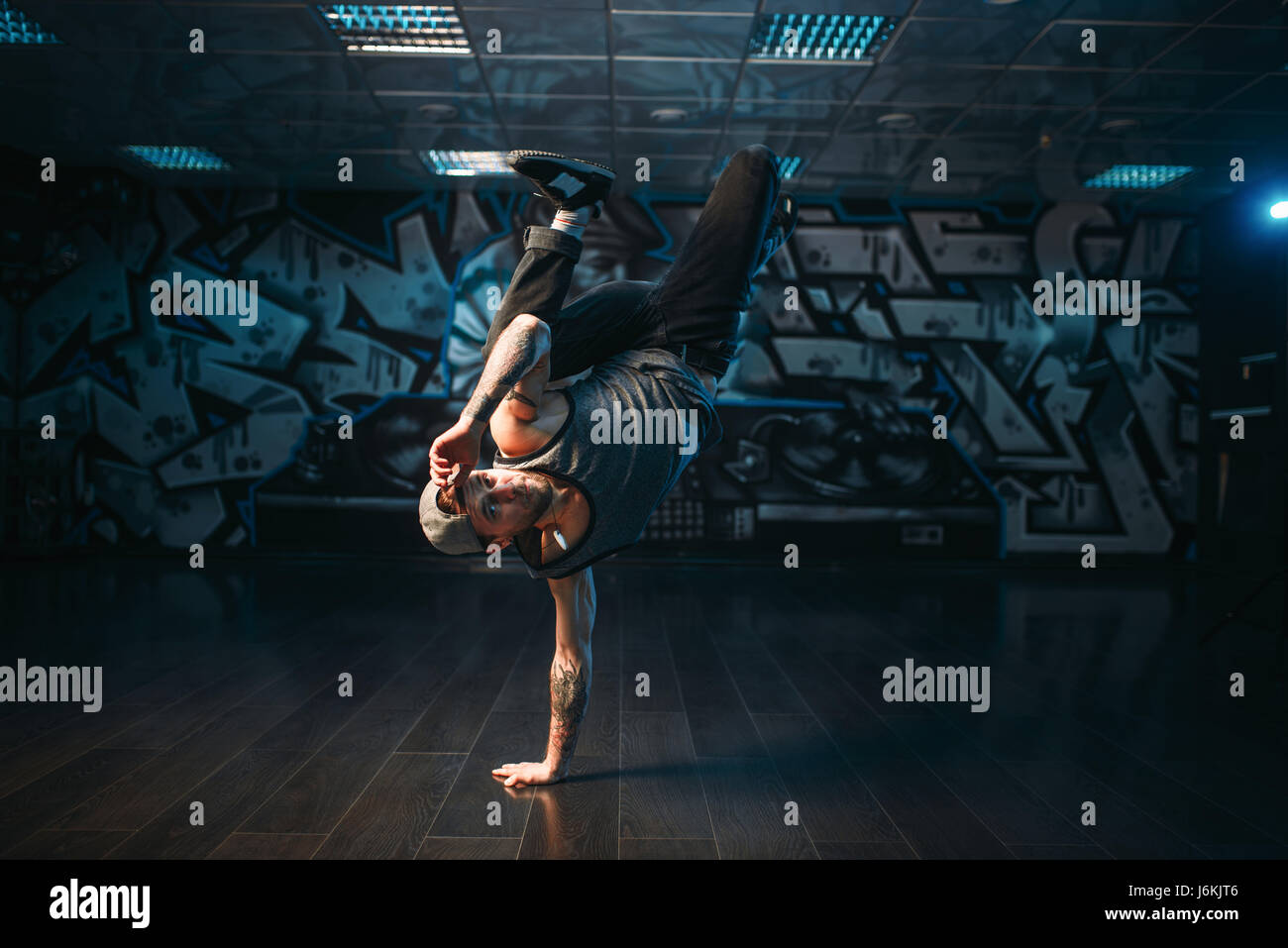 Breakdance performer posing in dance studio. Modern urban dancing style ...