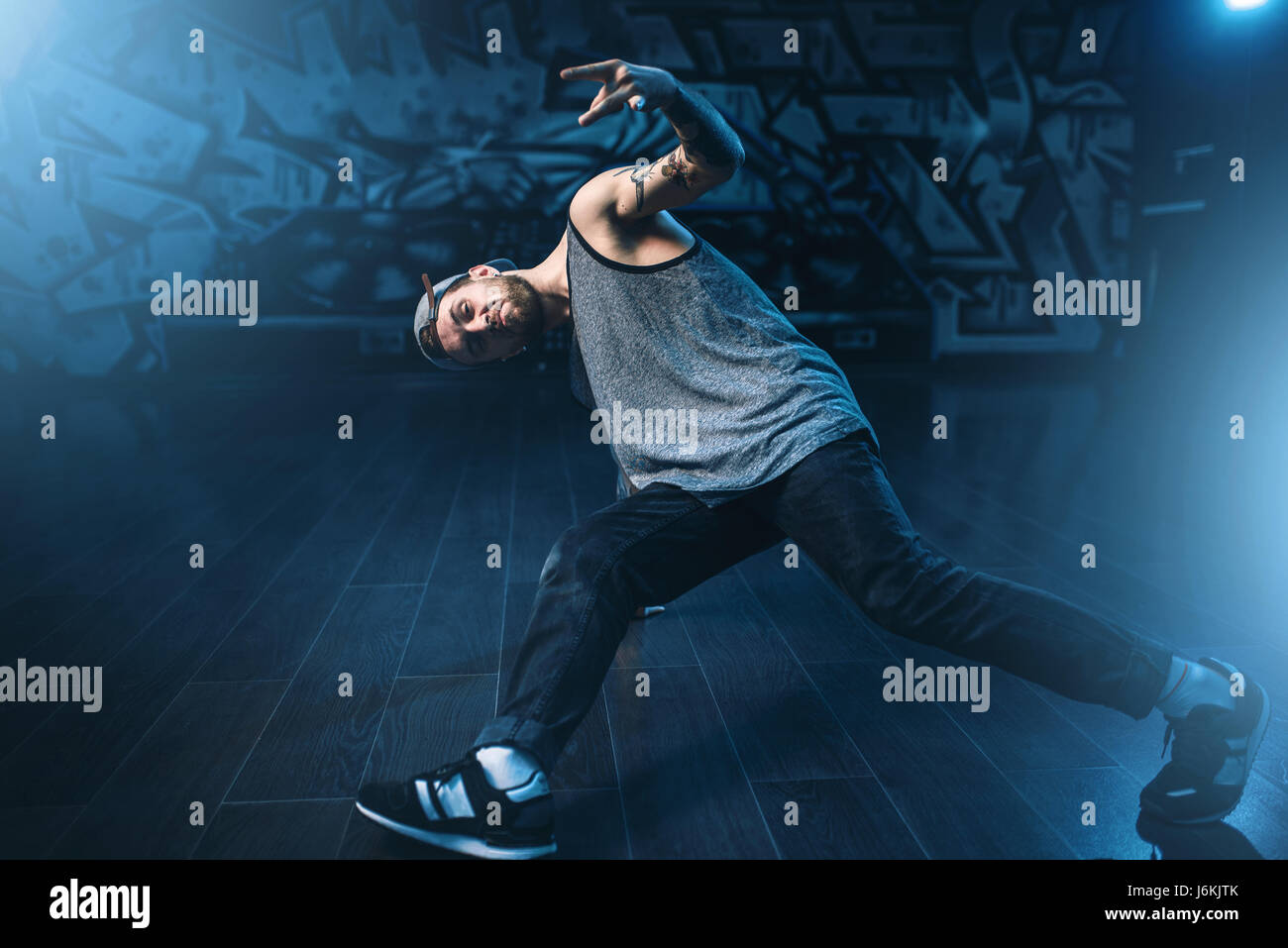 Breakdance performer posing in dance studio. Modern urban dancing style ...