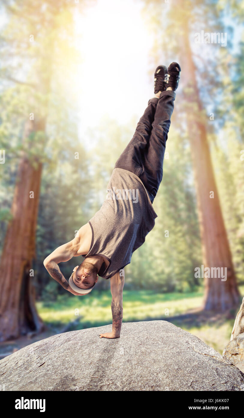 Breakdance performer, upside down motion in the forest. Modern dance ...