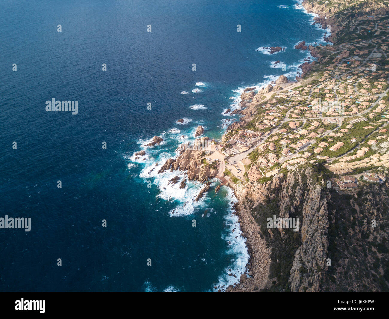 Aerial view of an Italian city on the coast of Sardinia at sunset ...