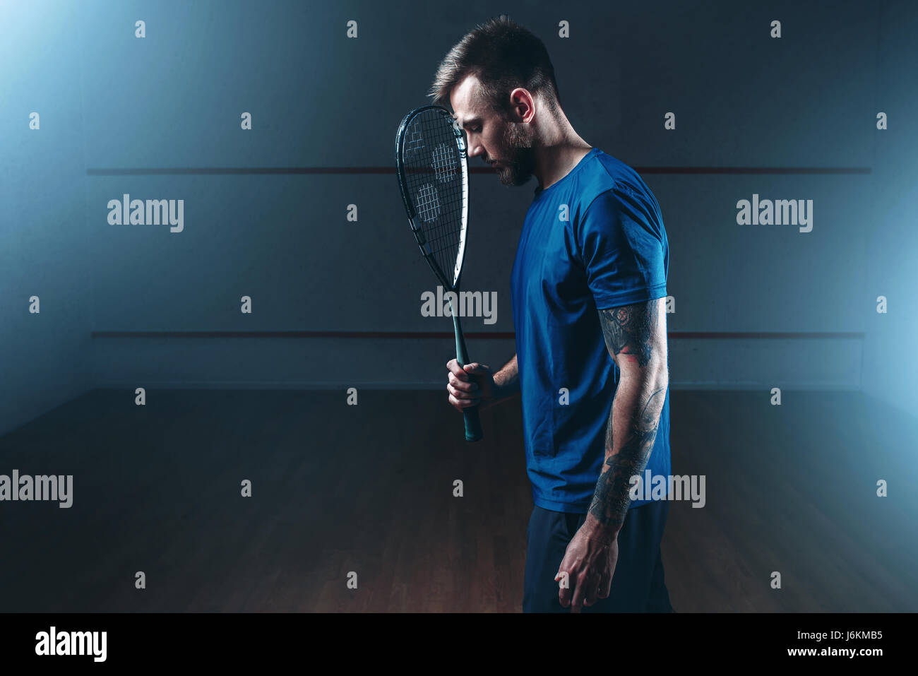 Squash game concept, male player with racket, indoor training court on ...