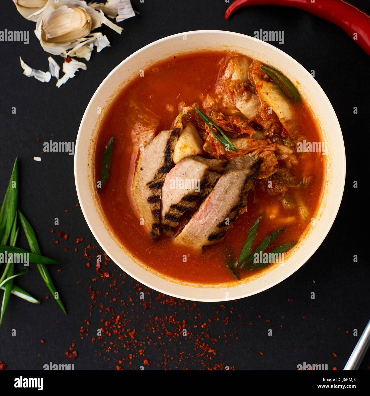Korean cuisine. Kimchi soup on black background Stock Photo - Alamy