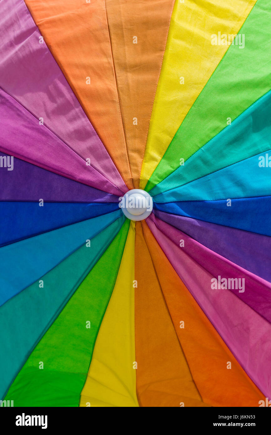 rainbow color beach umbrella closeup Stock Photo - Alamy
