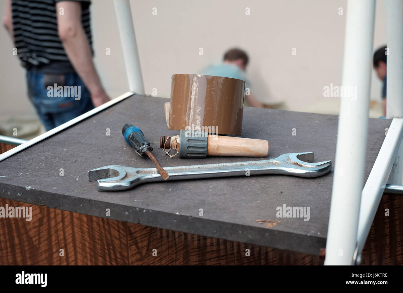 Tools And Three Workers Stock Photo - Alamy