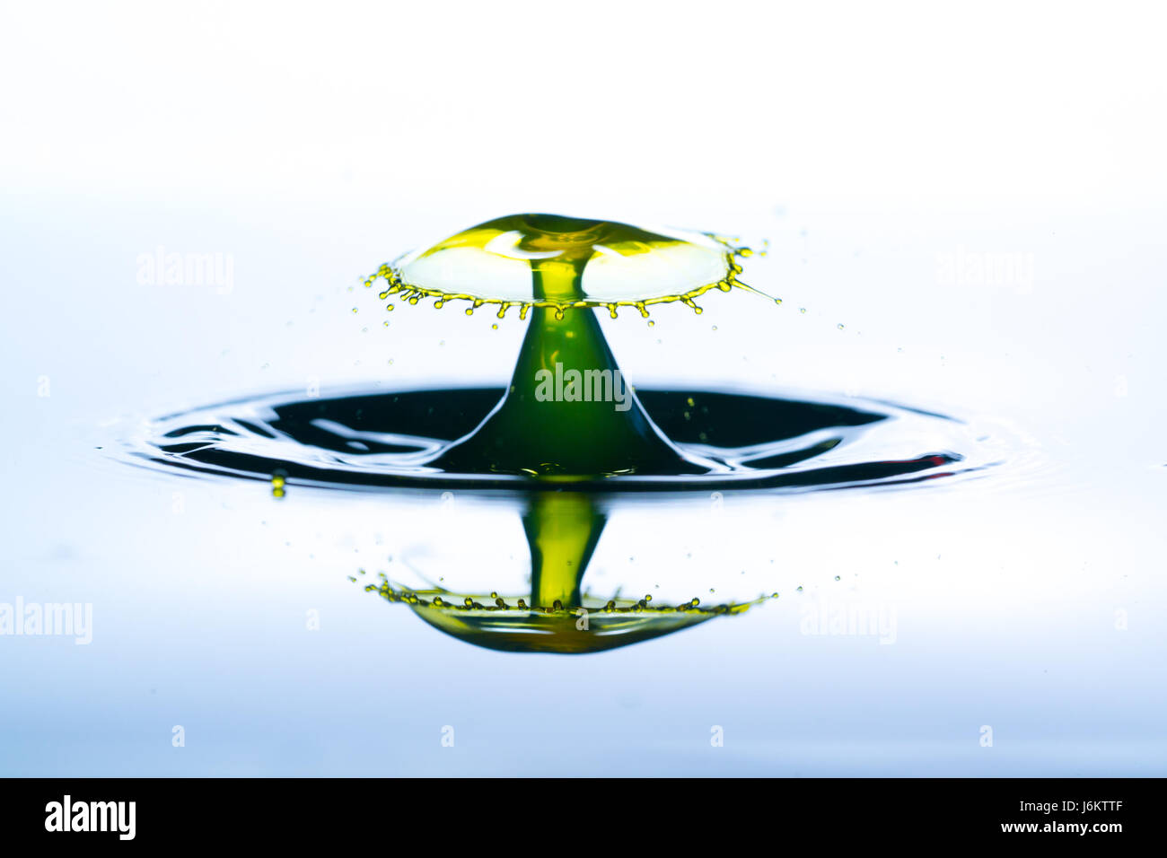 Water drop falling and drips on water mirror. Water drop splash and ...