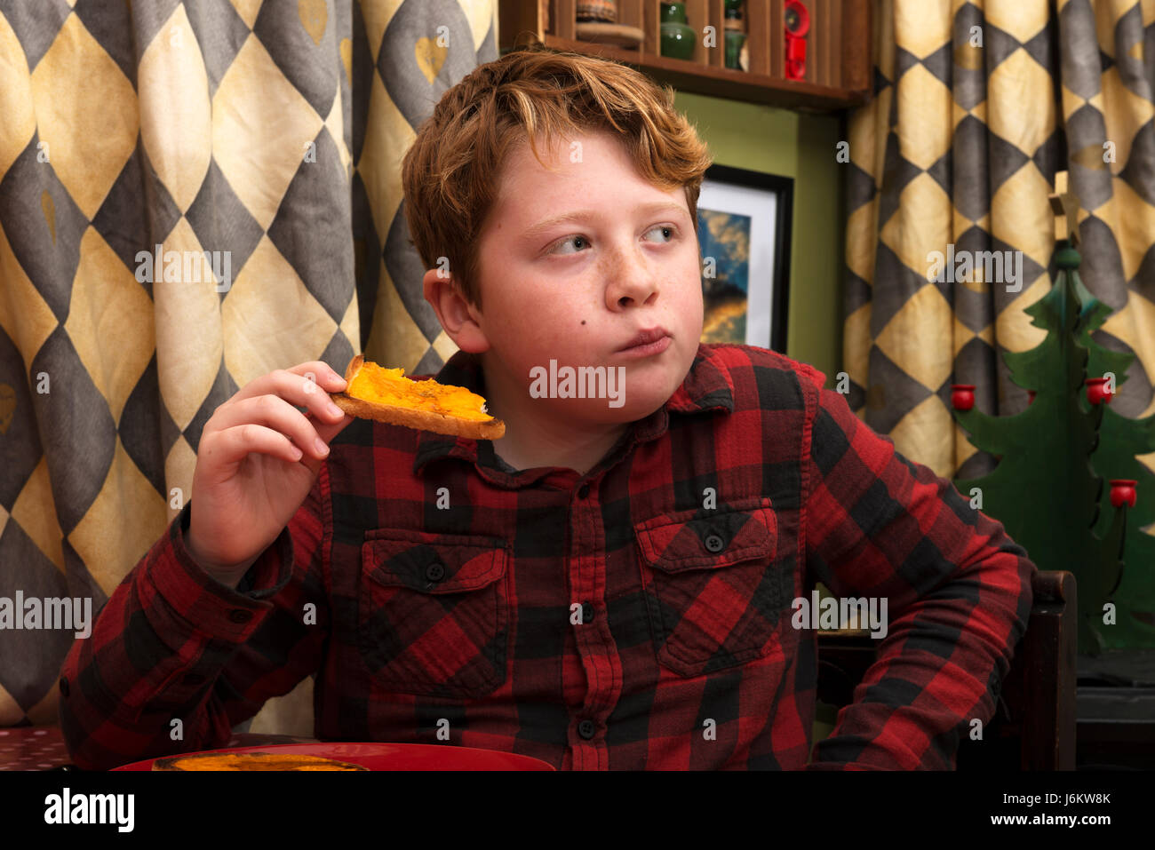 Boy eating cheese on toast Stock Photo - Alamy