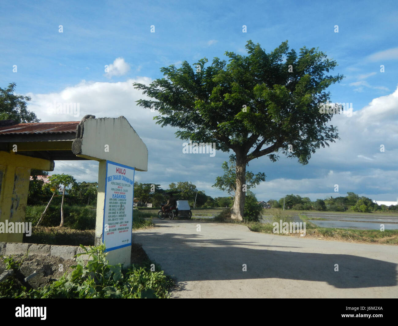 This image depicts a rural scene from Sitio Hulo, Hilerang Patubig in ...