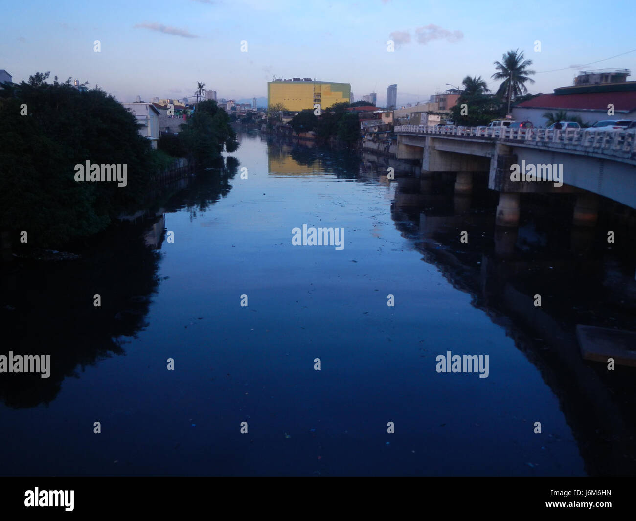 The image shows a scenic view of the sunset across the Pasig River ...