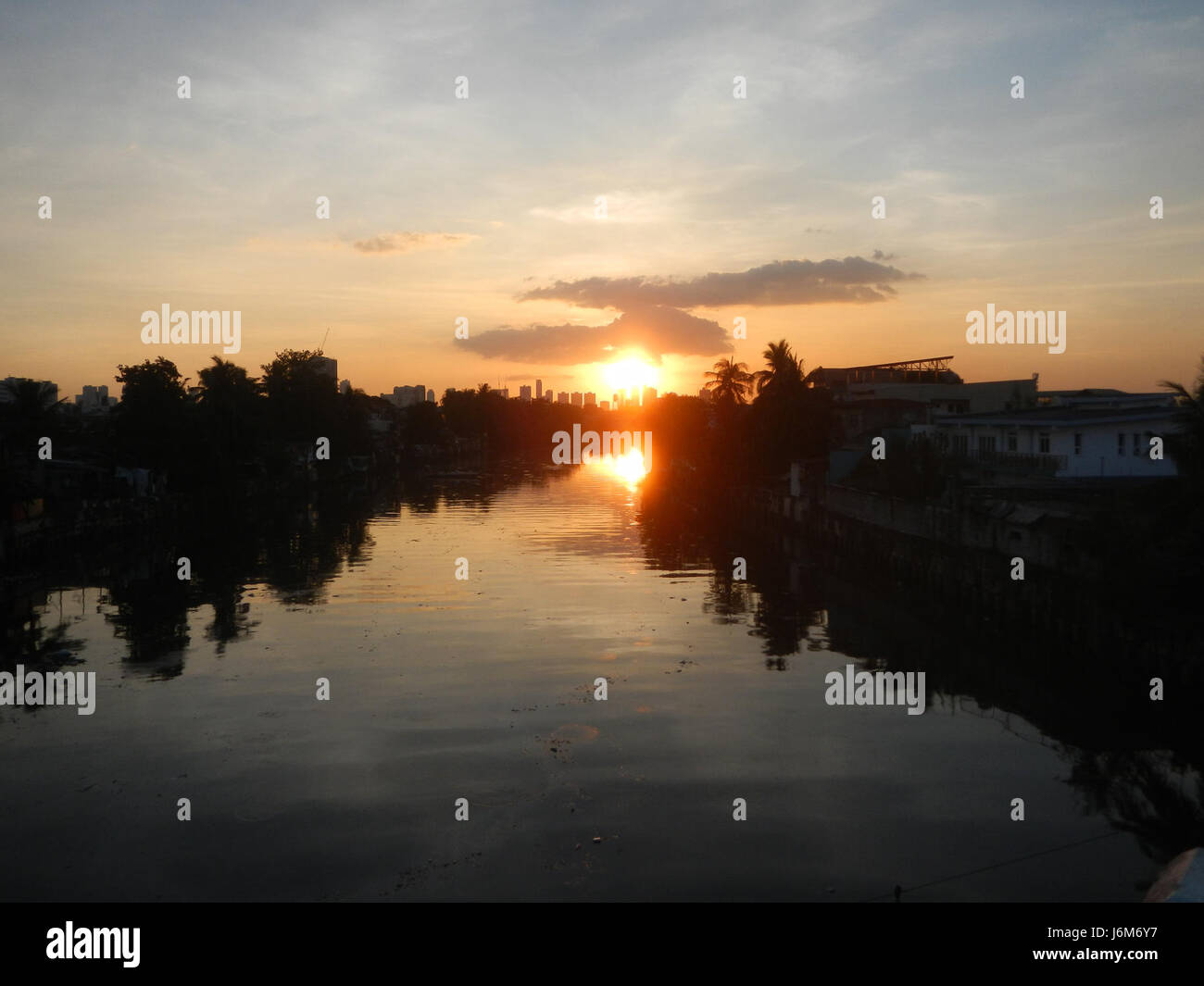 A photograph of the sunset over the Pasig River, captured from the ...