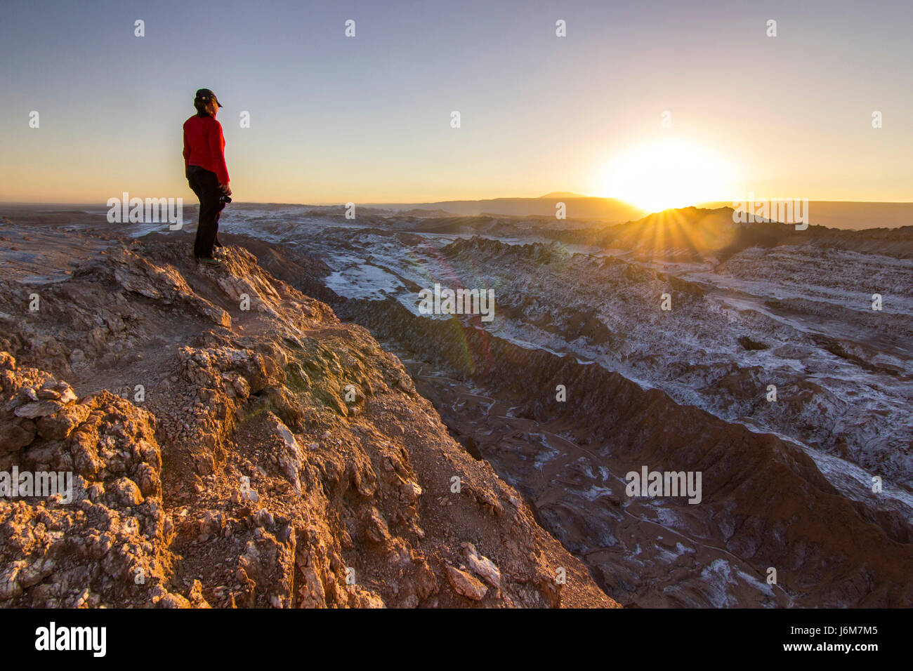 girl standing on a cliff with panoramic view in Moon valley in atacama ...