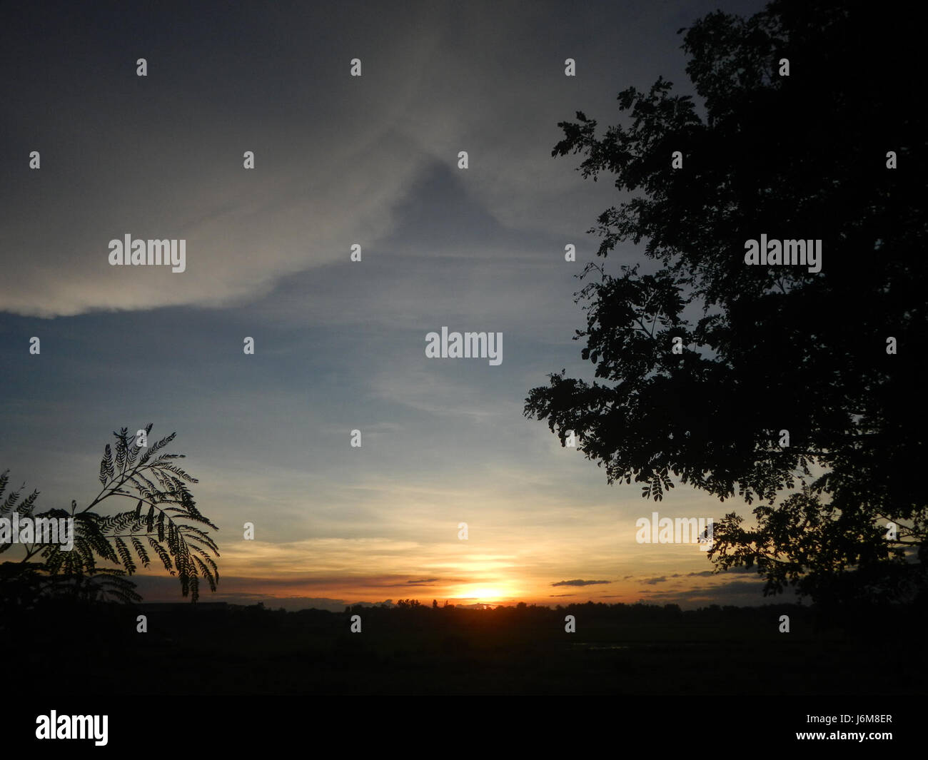 This photograph showcases a stunning sunset view in the rural provinces ...