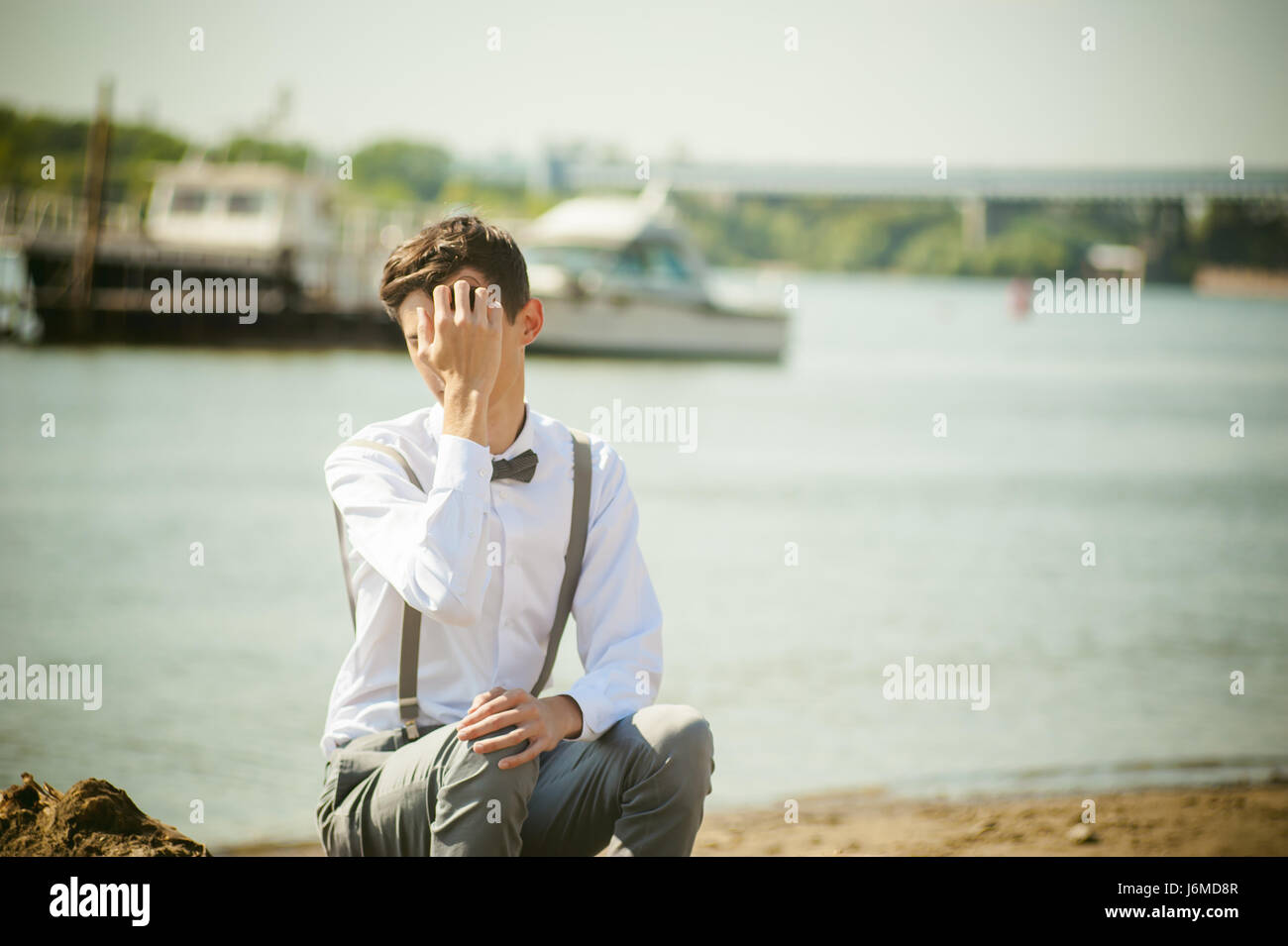young skinny man, elegantly stylishly dressed in white shirt, gray ...