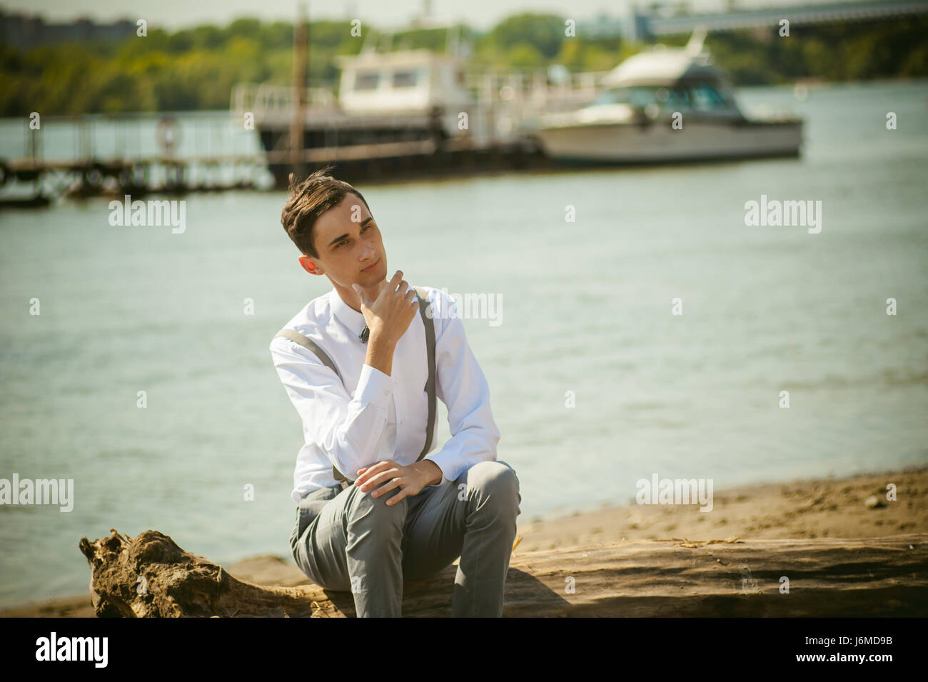 young skinny man, elegantly stylishly dressed in white shirt, gray ...