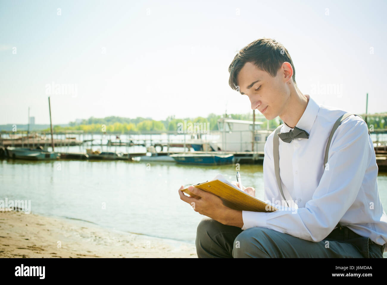 young skinny man, elegantly stylishly dressed in white shirt, gray ...