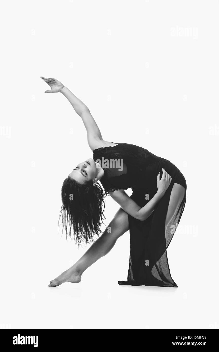 Beautiful modern dancer young woman in black flyings fabrics making ...