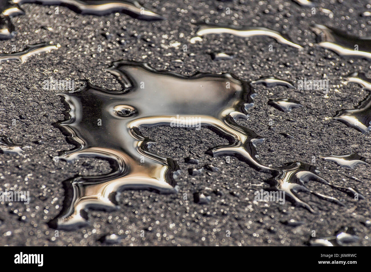 Rain water on fresh asphalt Stock Photo - Alamy