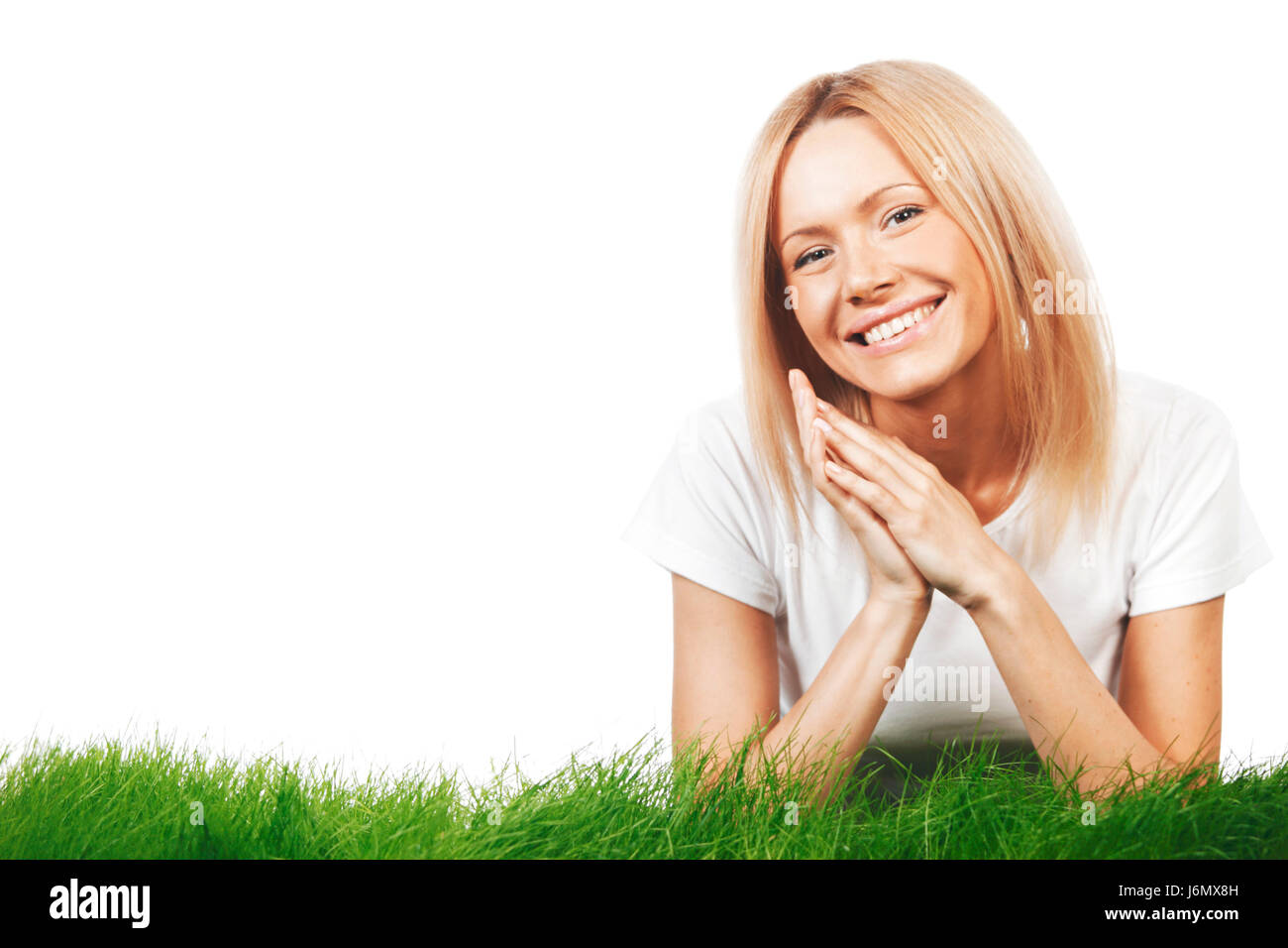 Smiling beautiful woman on grass isolated on white background Stock ...
